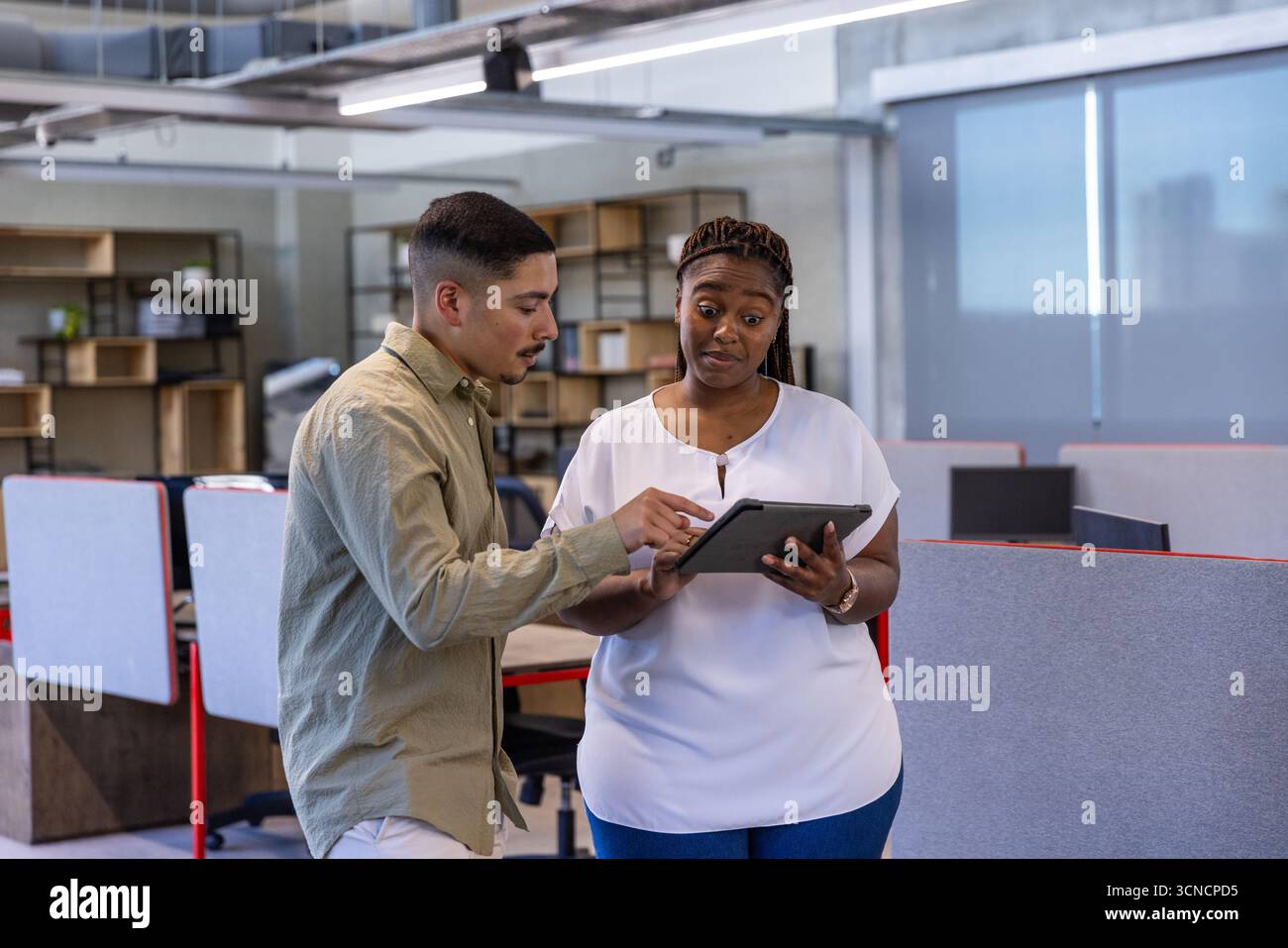 Diverse coworkers discussing details hi-res stock photography and ...