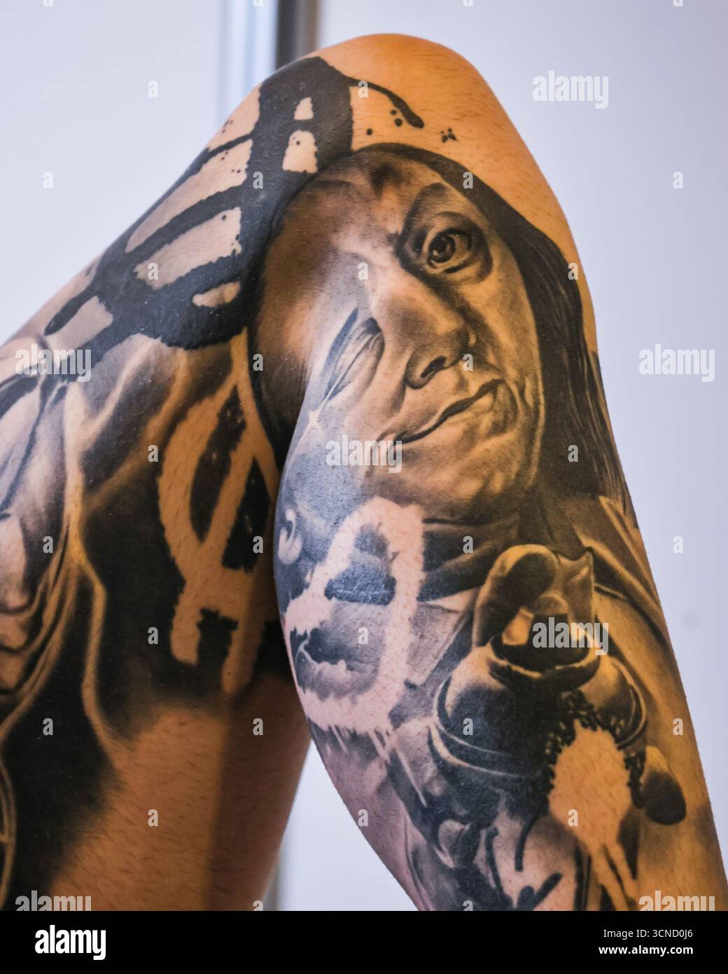 London, UK. 20th Sep, 2025. A tattoo artist and customer with work in ...