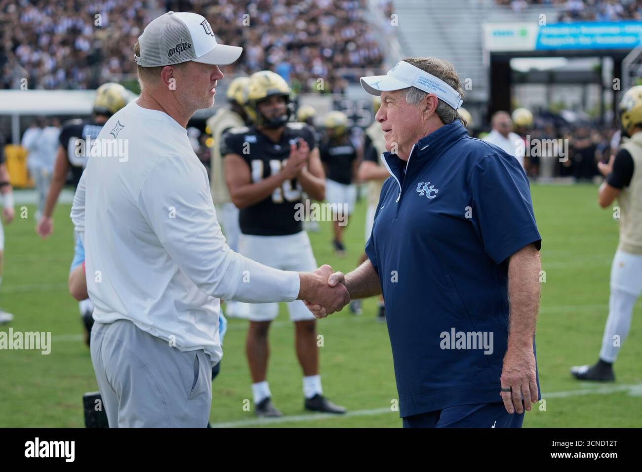 Central Florida head coach Scott Frost, left, and North Carolina head ...