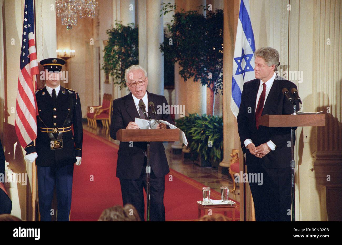 U.S. President Bill Clinton looking on as Israeli Prime Minister ...