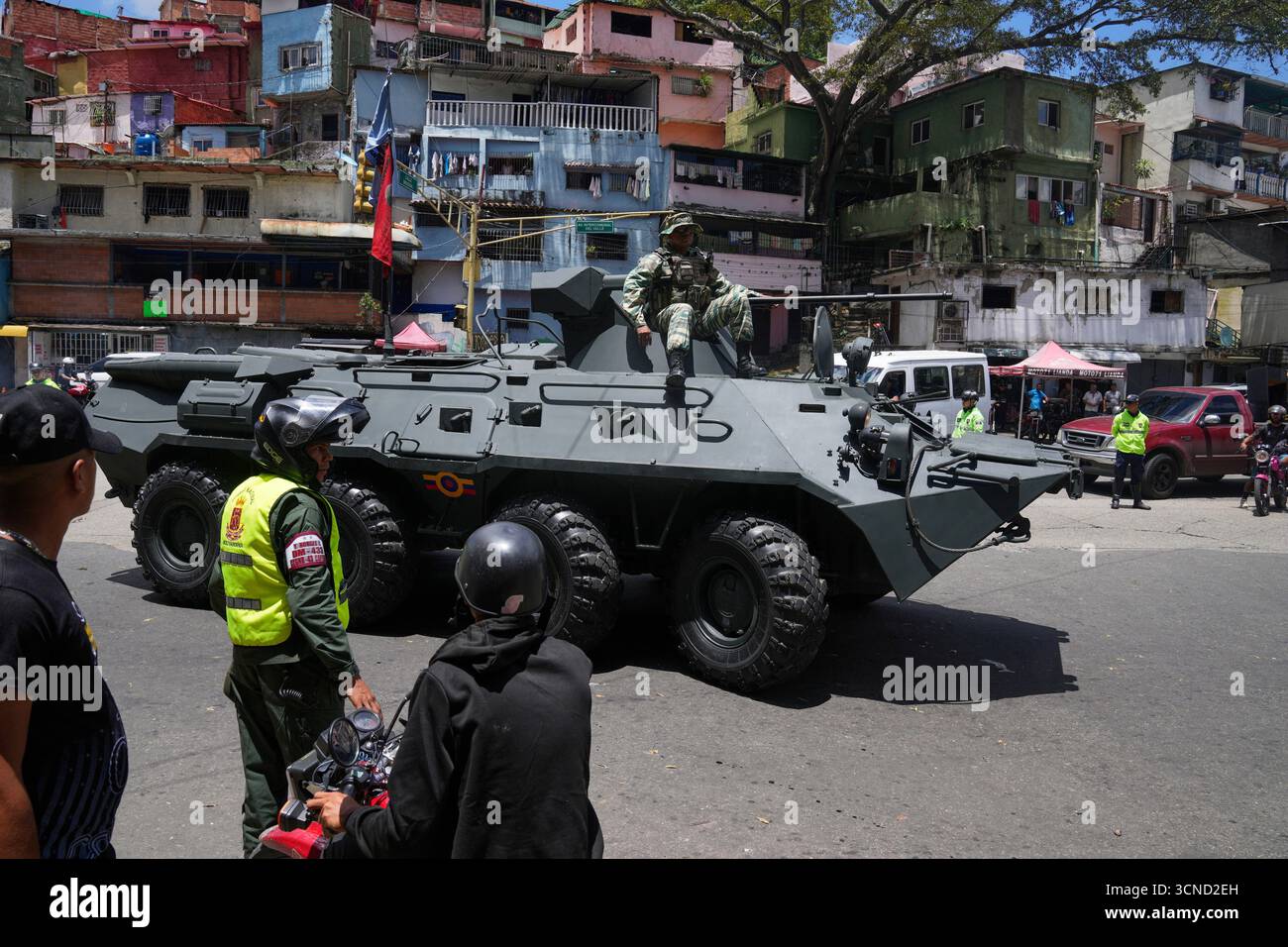 A soldier sits atop an armored car during military exercises in Caracas ...