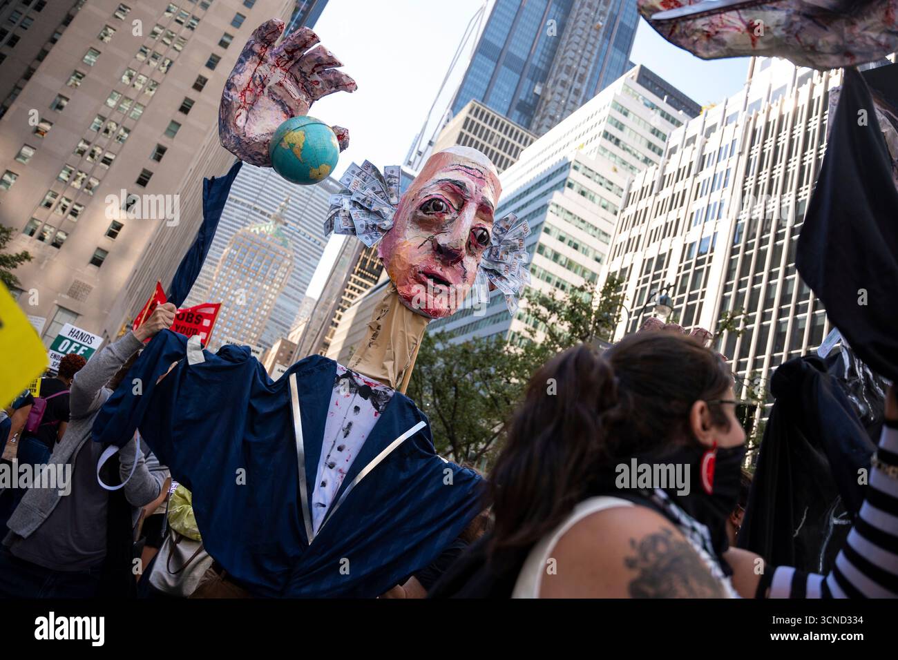 An art piece of Jeff Bezos with bloody hands carrying the globe is ...