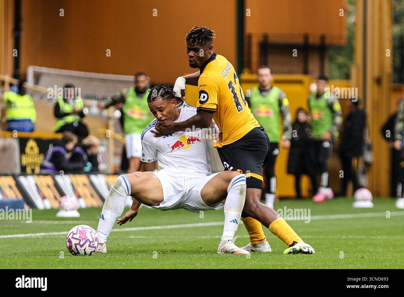 Emmanuel Agbadou (12 Wolves) pressures Noah Okafor (19 Leeds) during ...