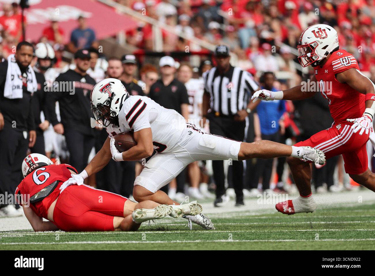 Texas Tech running back Cameron Dickey runs over Utah safety Nate ...
