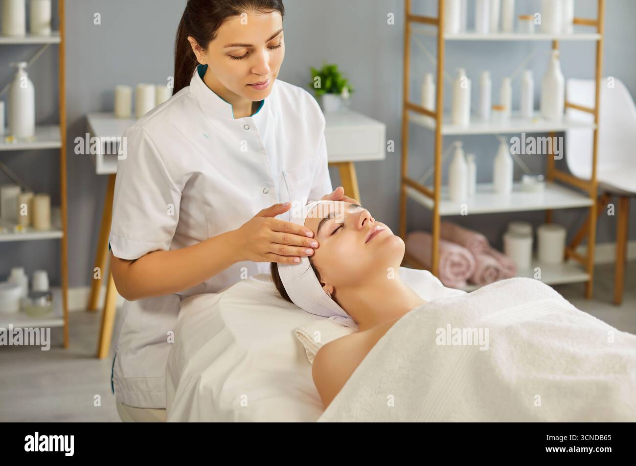 Beautiful woman performing facial massage hi-res stock photography and ...