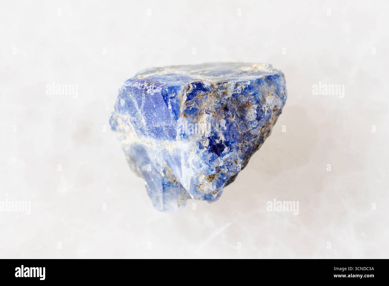 sample of raw benitoite stone on white marble background close up from ...