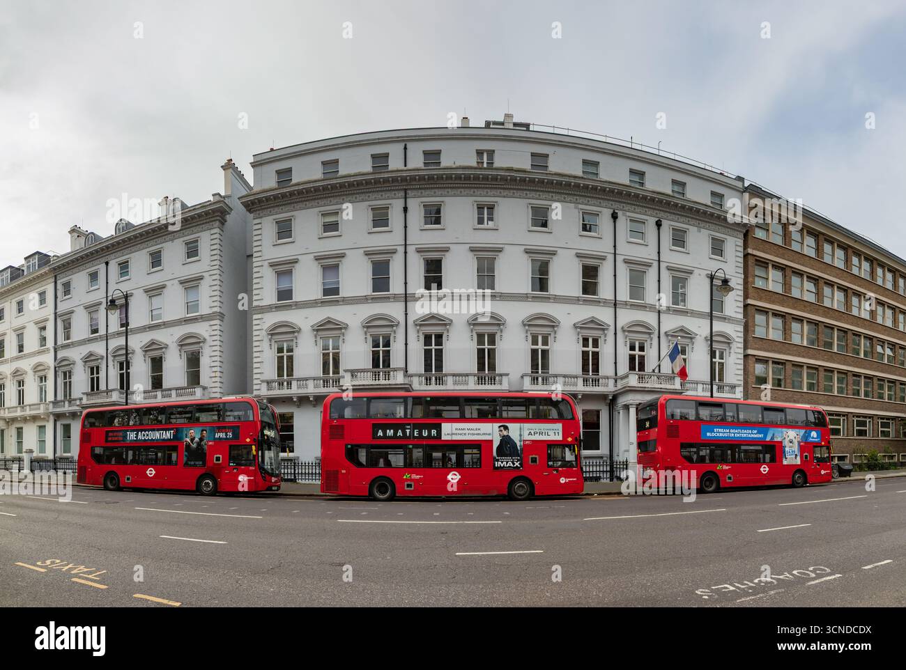 A picture of three iconic red double-decker buses in London, with ads ...