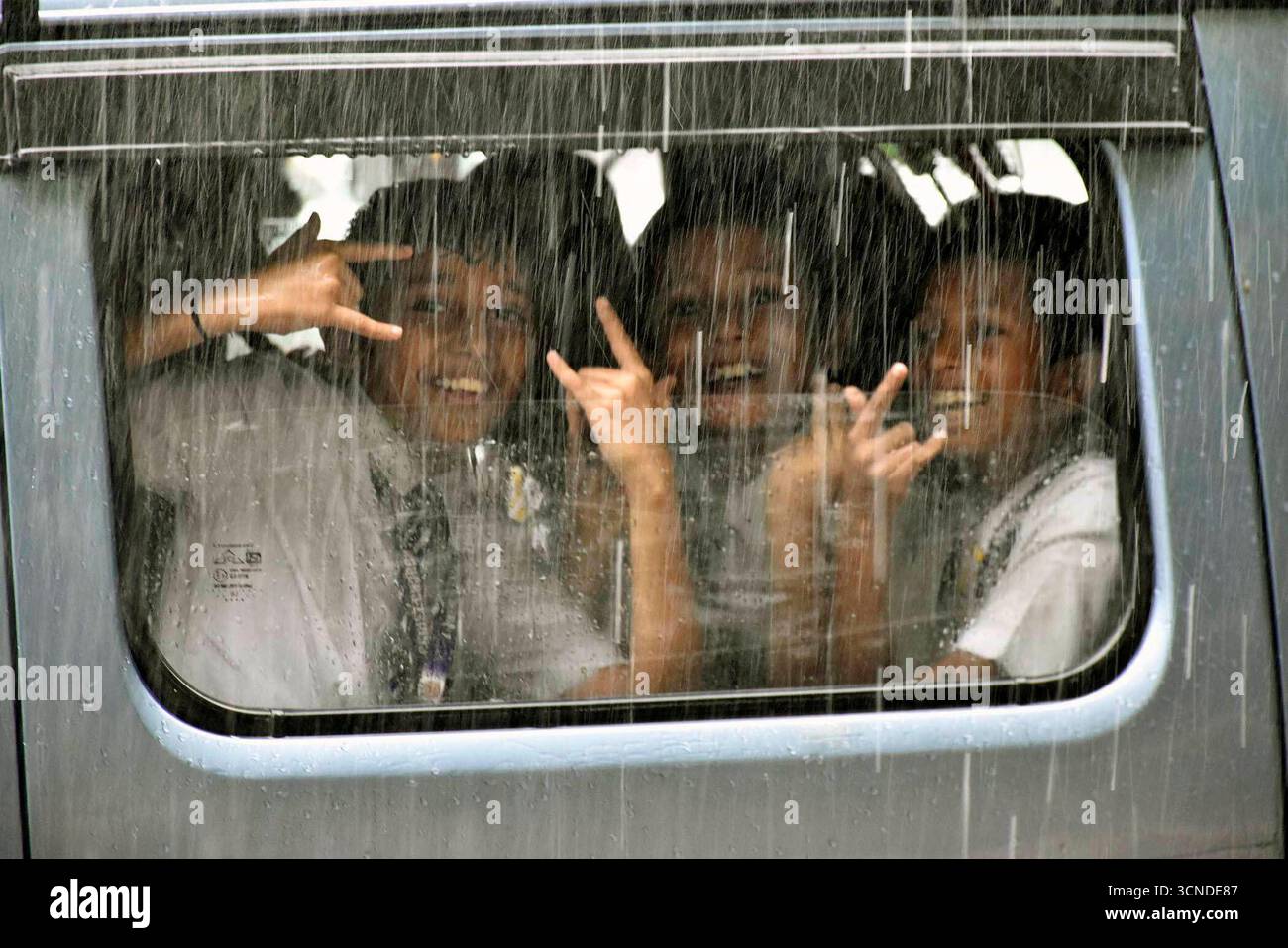 PATNA, INDIA - SEPTEMBER 20: School children enjoying during heavy rain ...