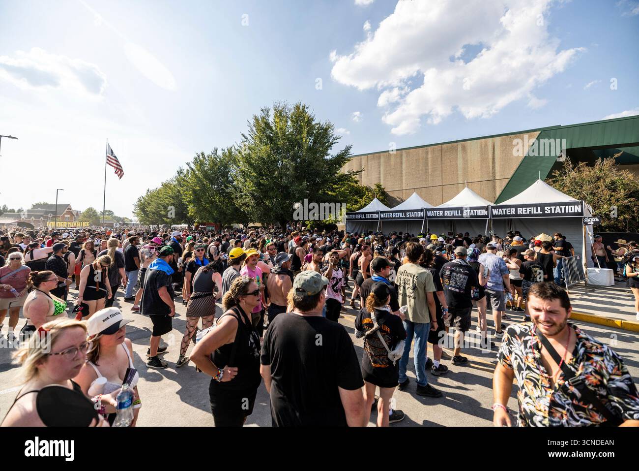 Festivalgoers are seen at water refill stations during the Louder Than ...