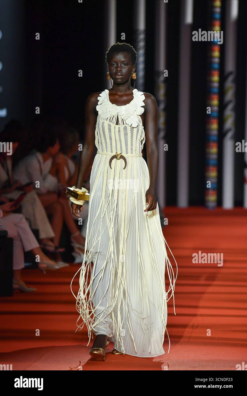 A model walks the runway wearing a design by Dolores Cortes during the ...