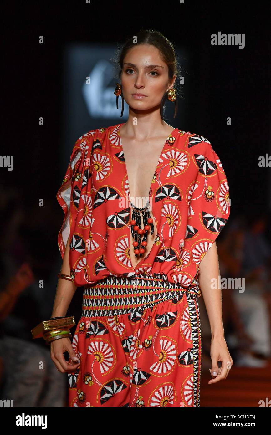 A model walks the runway wearing a design by Dolores Cortes during the ...