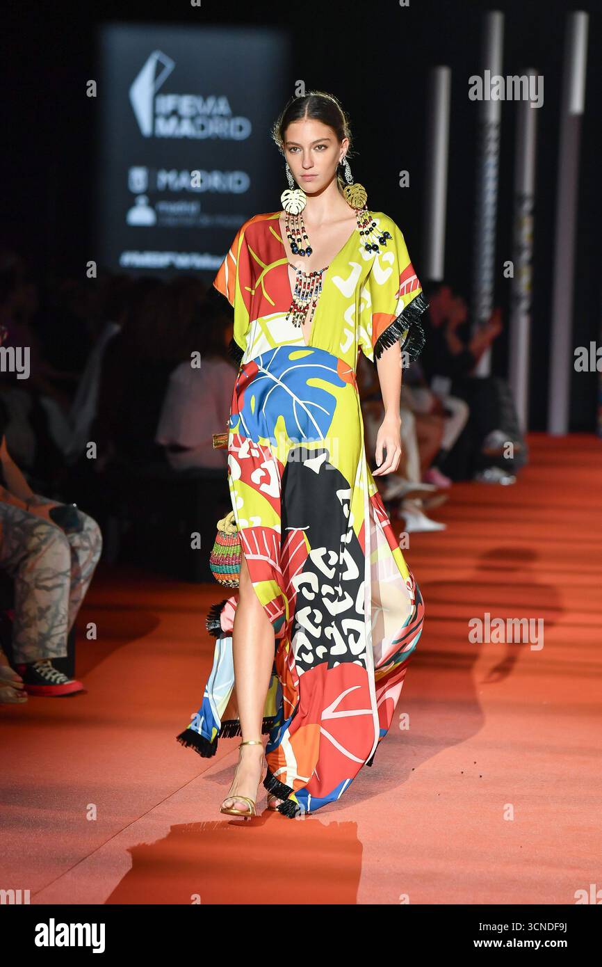 A model walks the runway wearing a design by Dolores Cortes during the ...