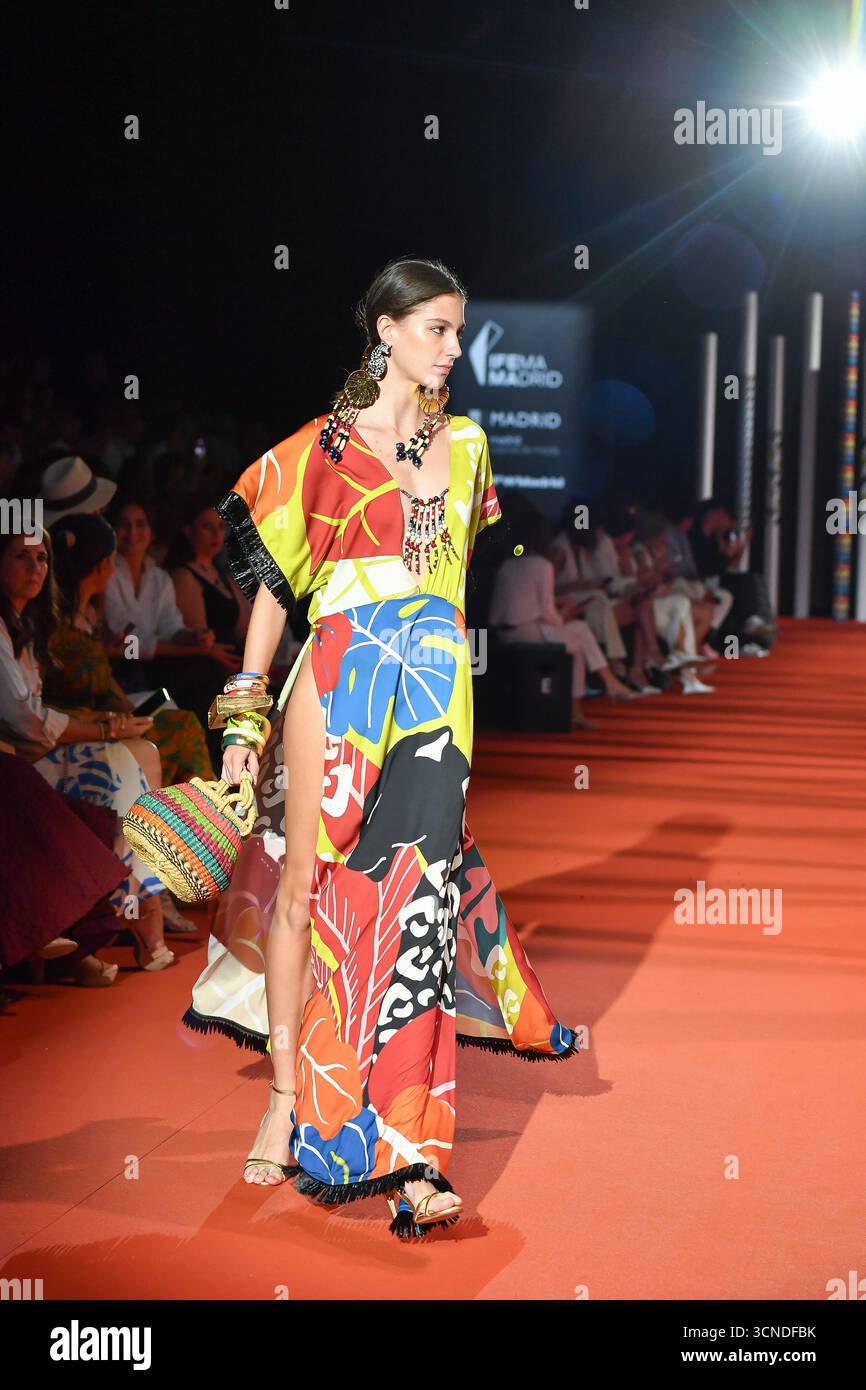 A model walks the runway wearing a design by Dolores Cortes during the ...