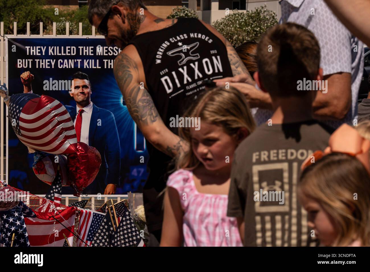 People visit a makeshift memorial outside the Turning Point USA ...