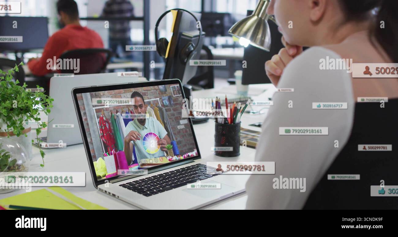 Watching female employee viewing colleague holding color wheel on ...