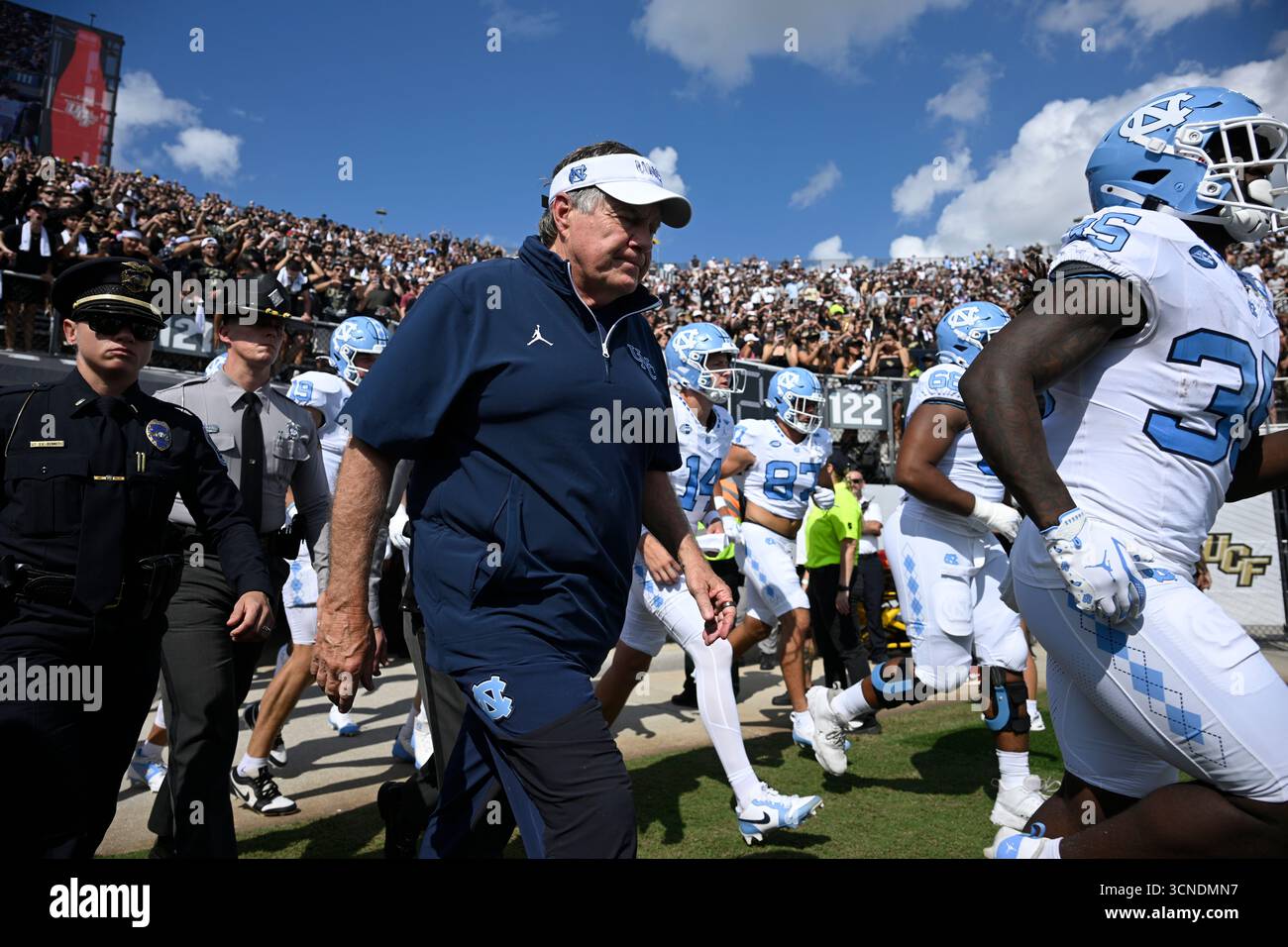North Carolina head coach Bill Belichick, center, takes the field ...