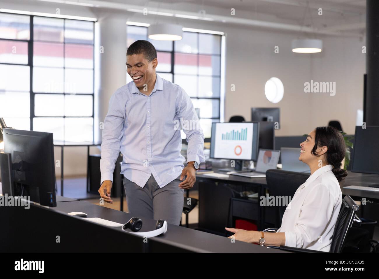 Diverse coworkers walking and sitting in open-plan office, female ...