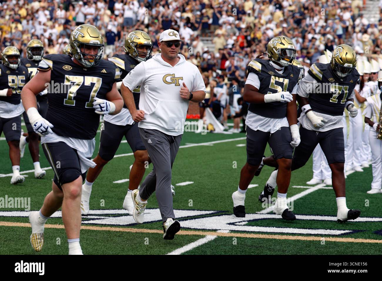 Georgia Tech head coach Brent Key, center left, leads his team onto the ...