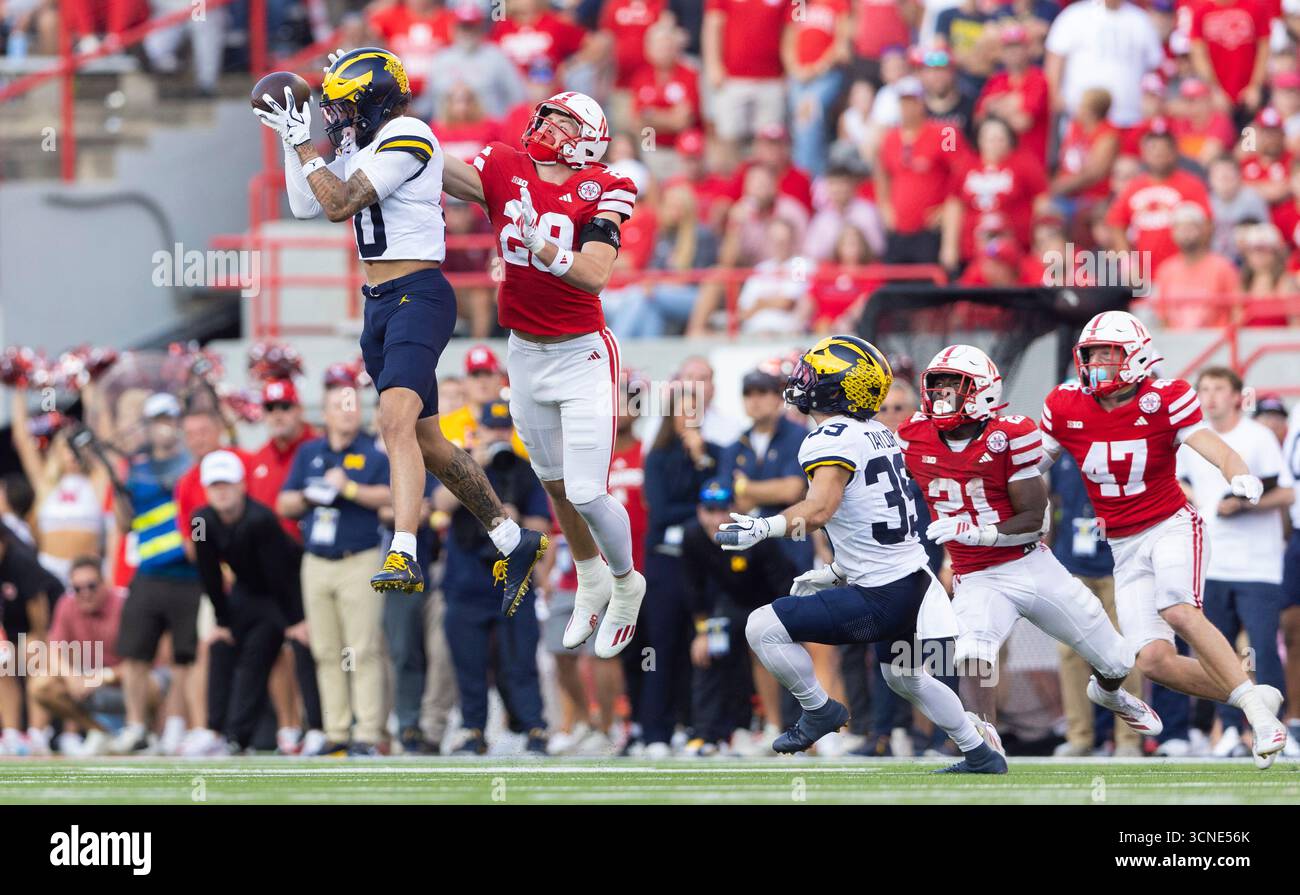 Michigan's Kendrick Bell, left, catches an onside kickoff return ...
