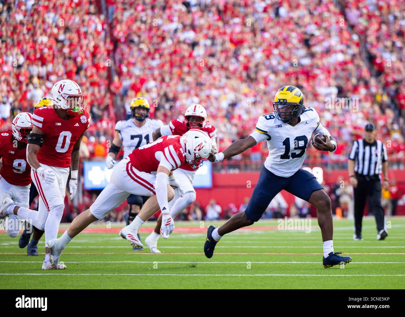 Michigan quarterback Bryce Underwood, right, holds off Nebraska's Rex ...