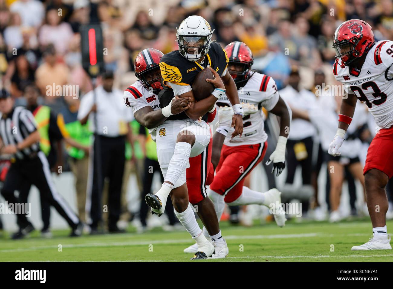 Kennesaw State quarterback Amari Odom (2) is tackled by Arkansas State ...