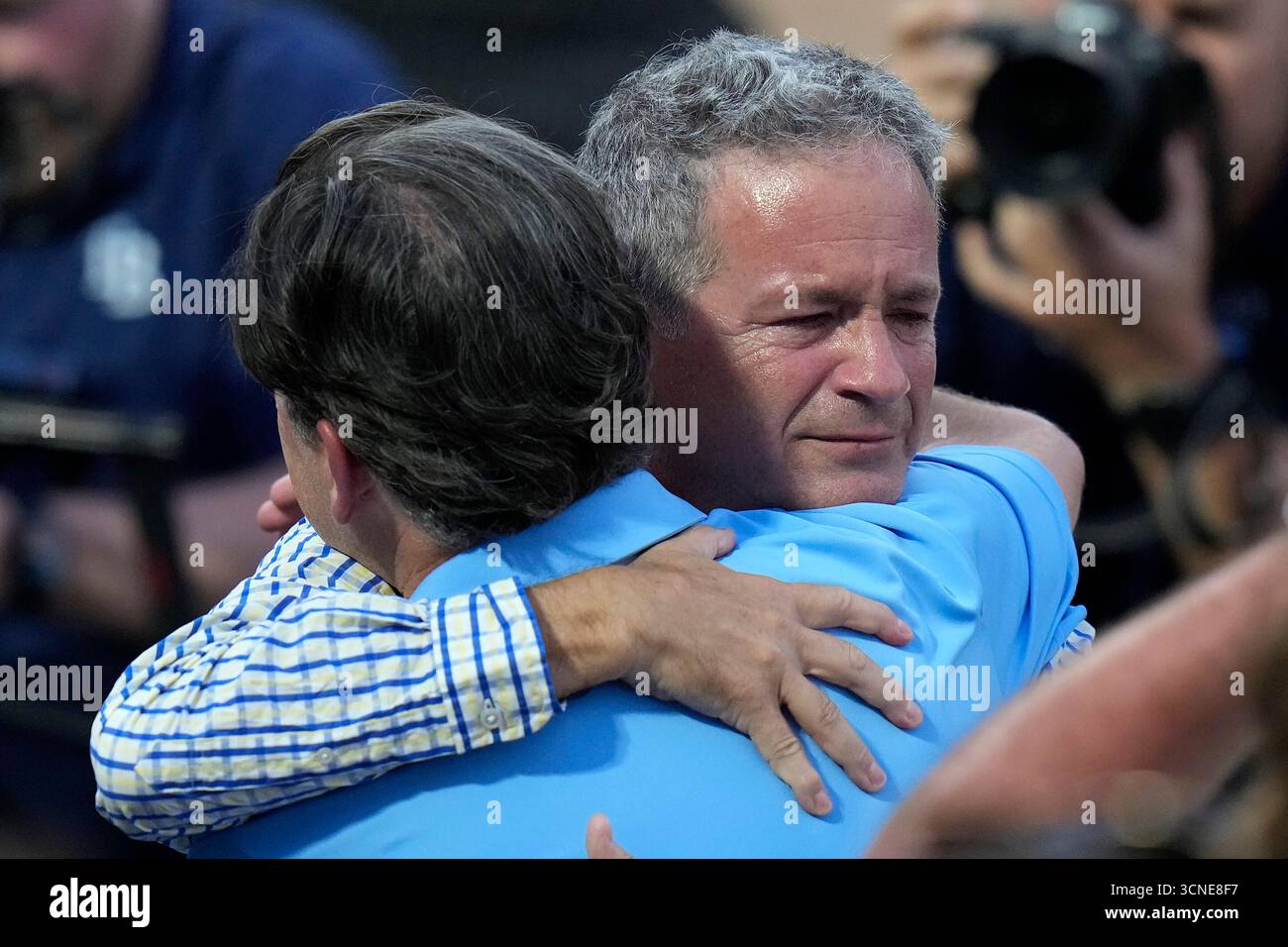 Tampa Bay Rays owner Stuart Sternberg, right, hugs president Brian Auld ...