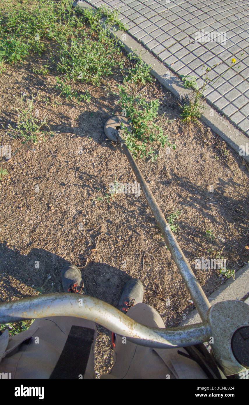 Circular saw blade strimmer in action. First person view Stock Photo ...