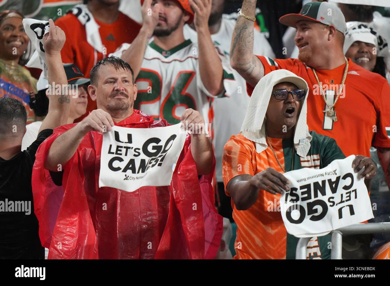 Miami fans cheer the team during the first half of an NCAA college ...