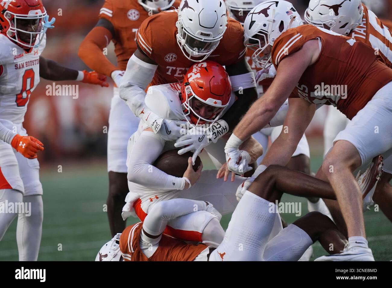 Sam Houston State quarterback Hunter Watson, center, is sacked by Texas ...