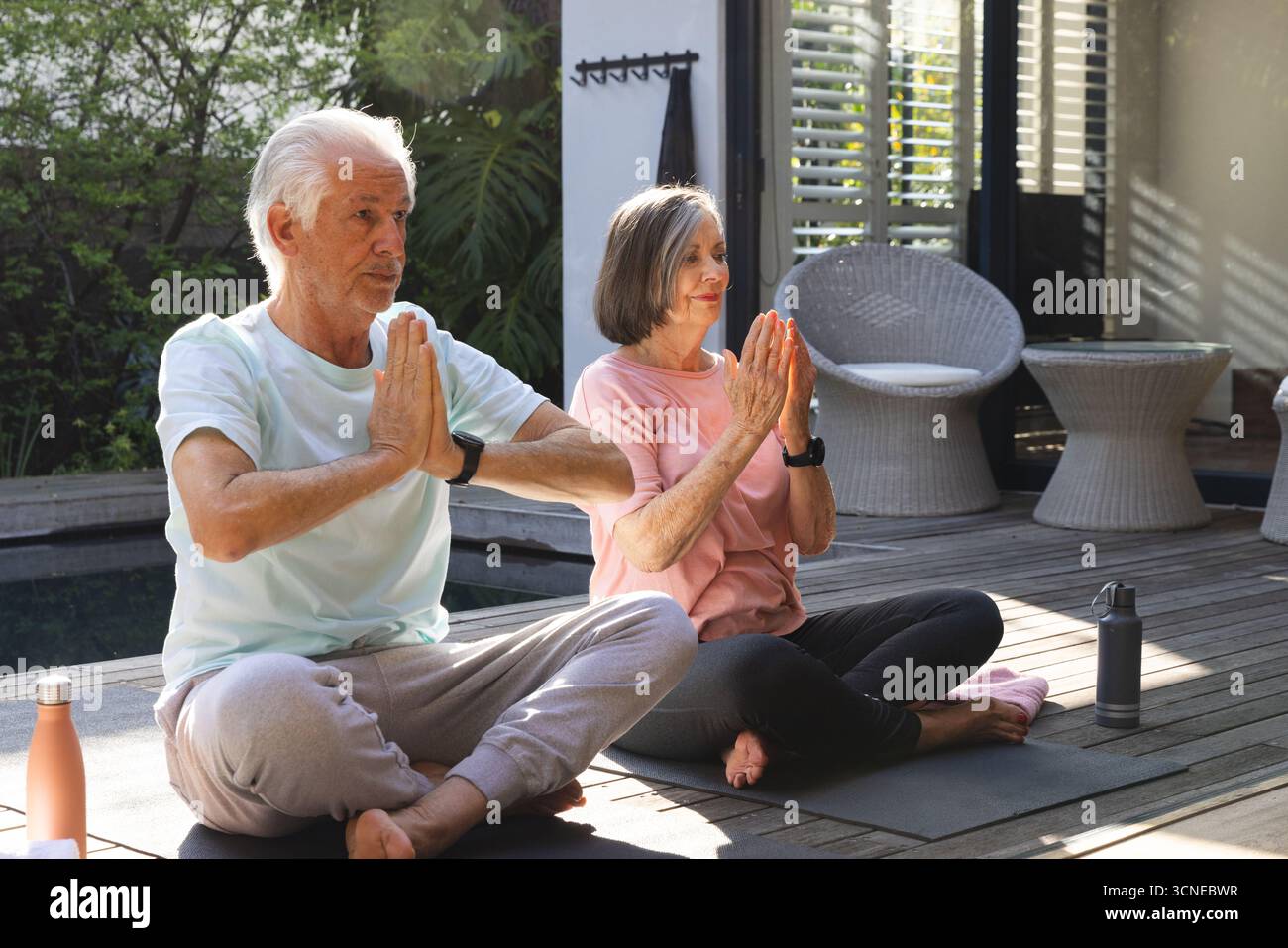 Senior couple meditating holding hi-res stock photography and images ...