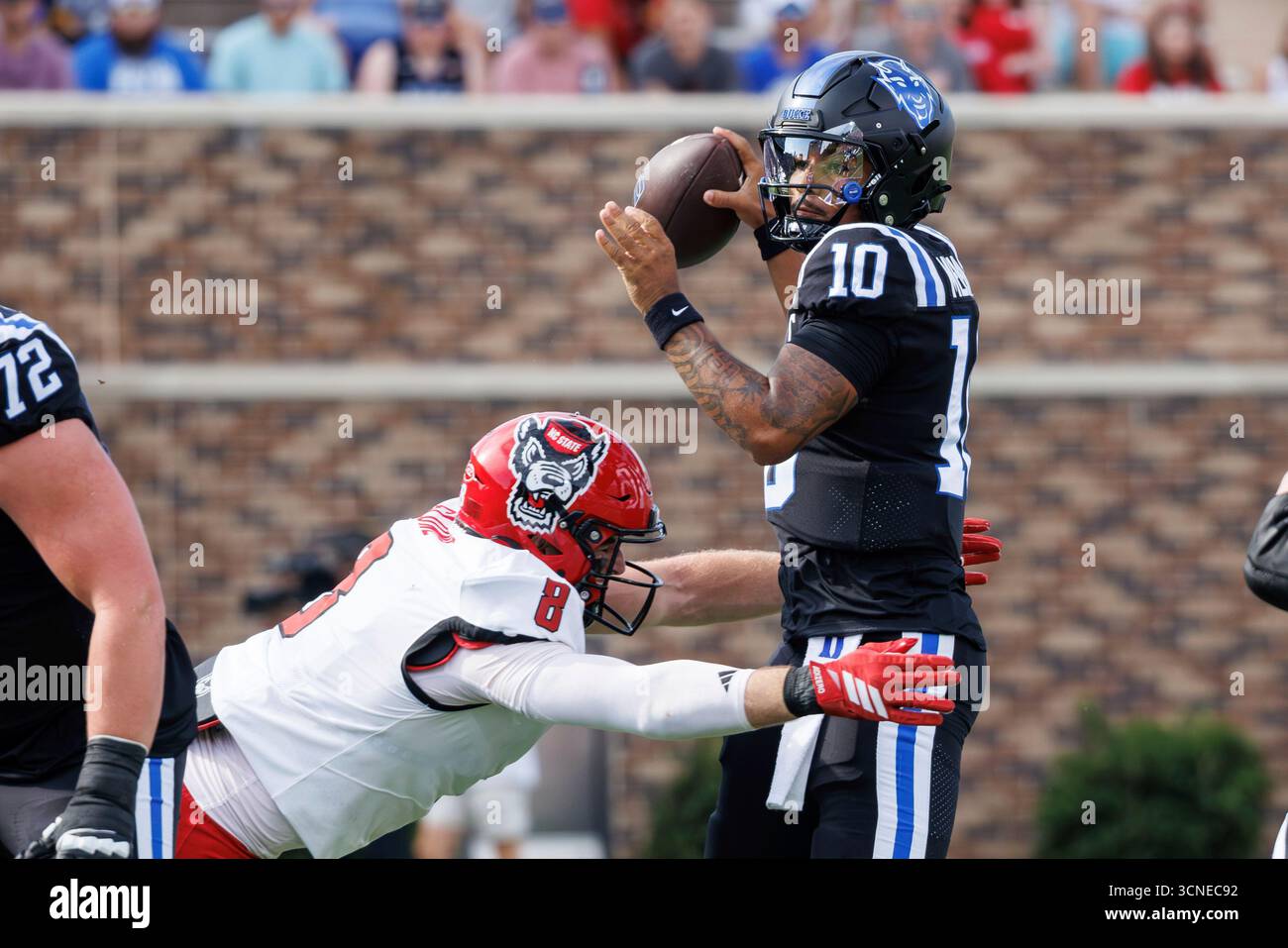 Duke's Darian Mensah (10) is hit as he throws by North Carolina State's ...