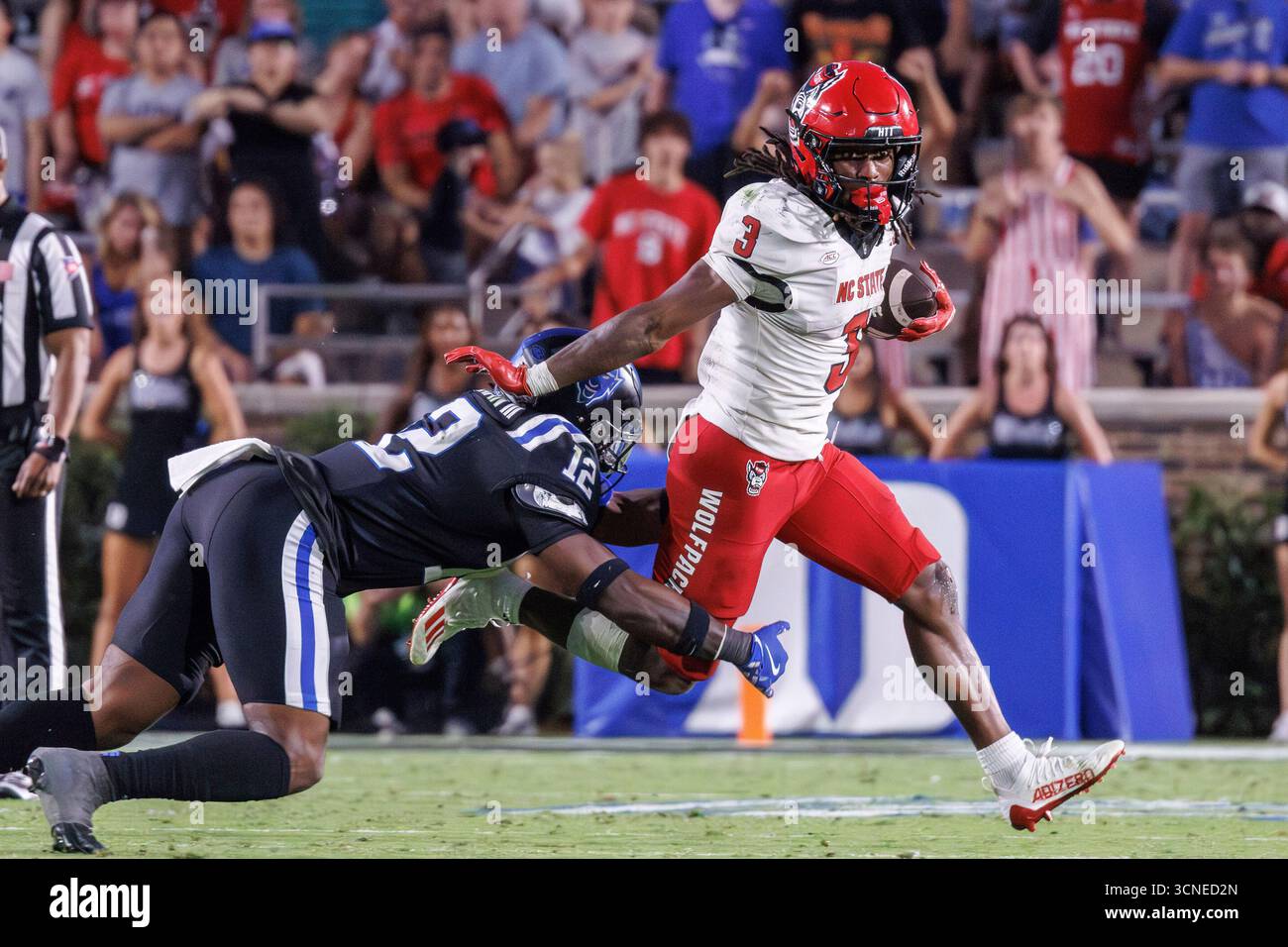 North Carolina State's Hollywood Smothers (3) is tackled by Duke's Tre ...