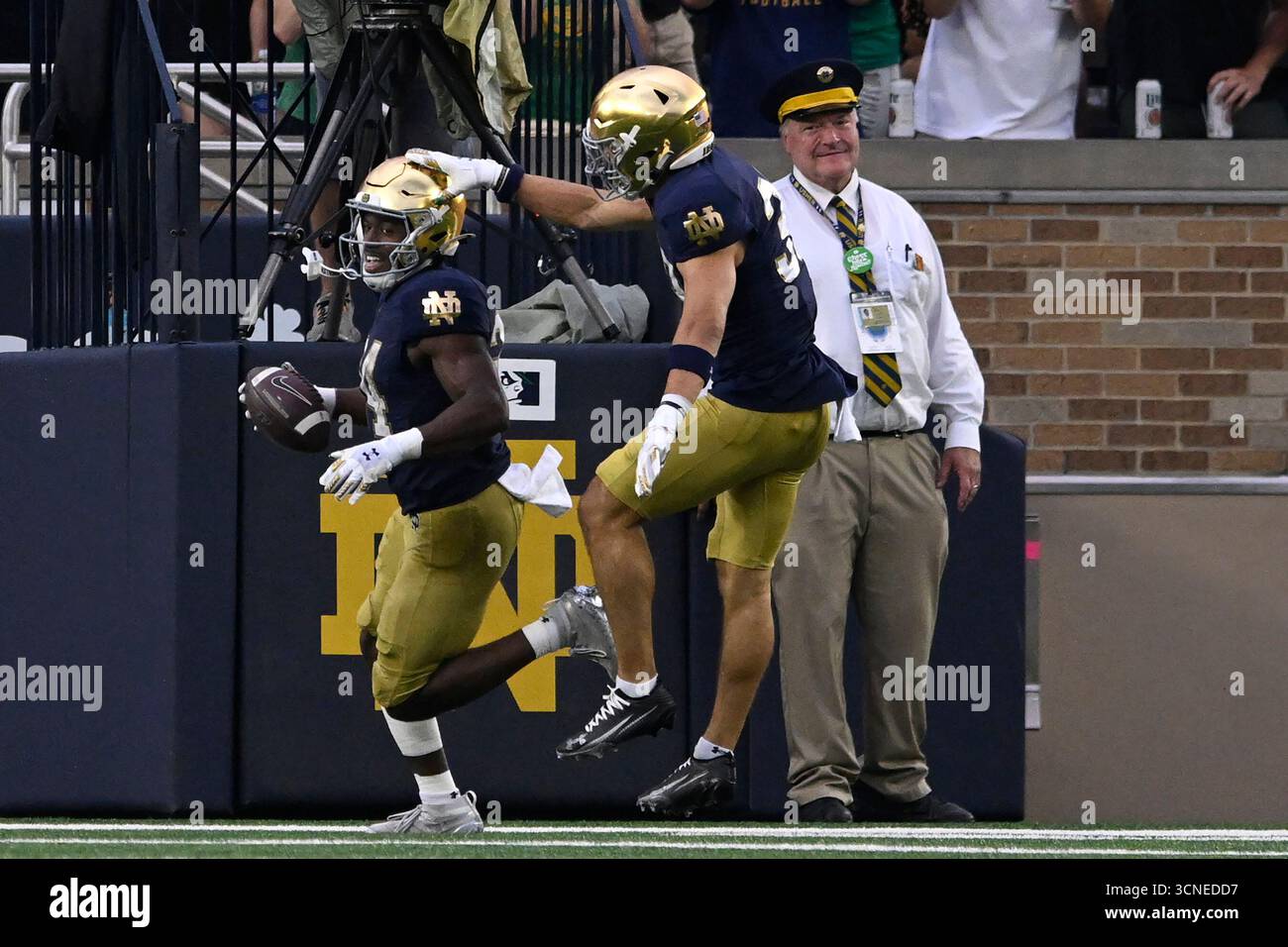 Notre Dame's Jadarian Price, left, celebrates with teammate Christopher ...