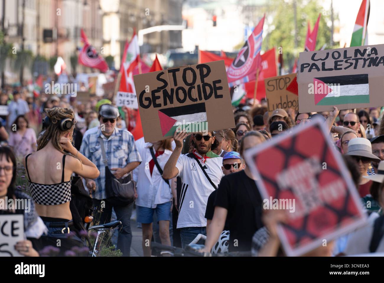 A protester holds a placard saying "Stop Genocide" during the rally ...