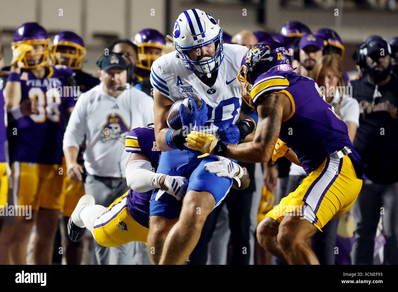 BYU tight end Carsen Ryan, front left, prepares to be hit by East ...
