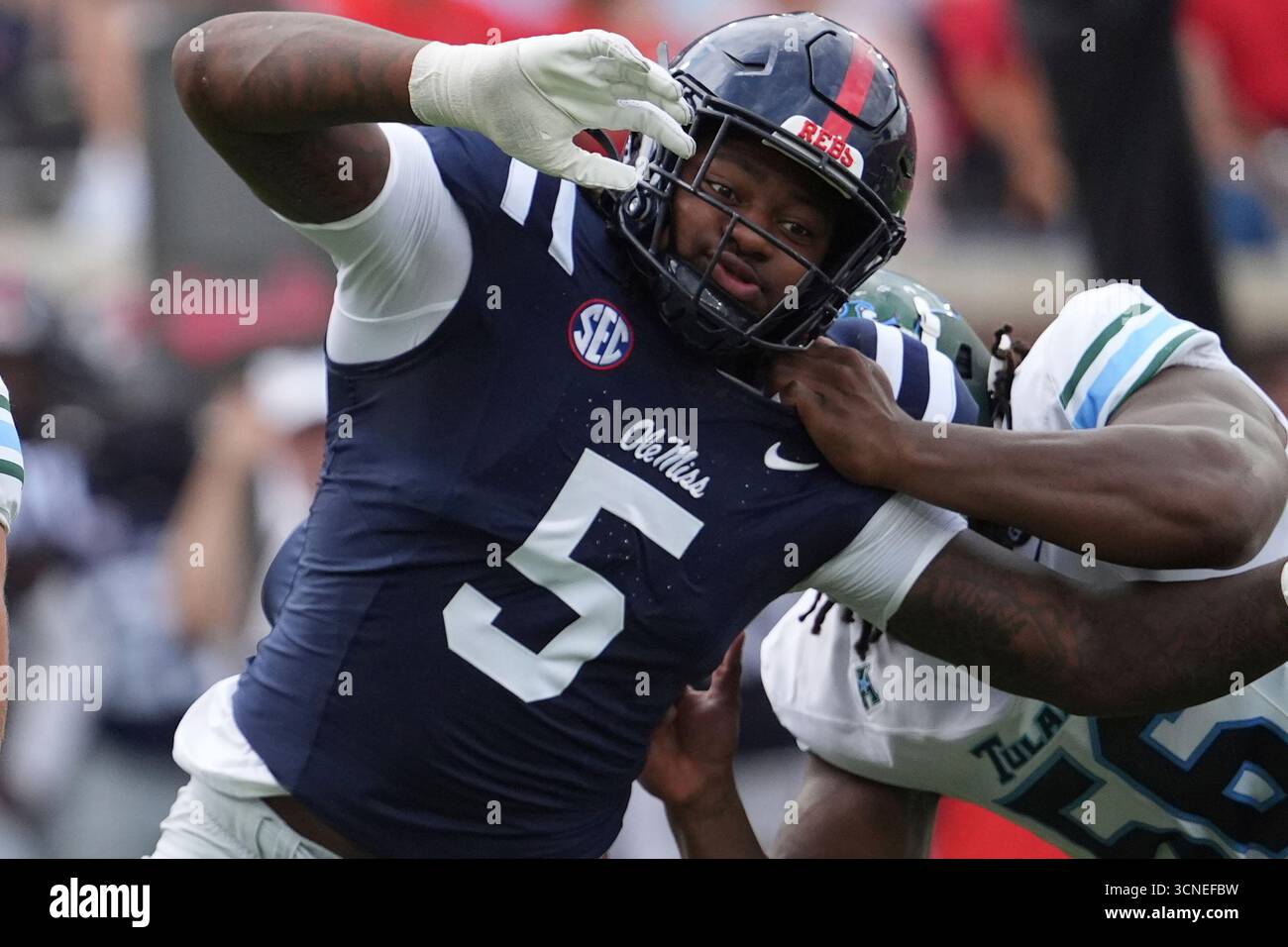Mississippi defensive end Kam Franklin (5) fights off a block by Tulane ...