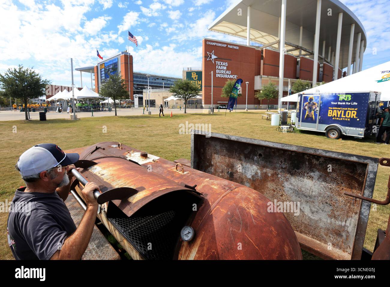 Jimmy Hancock with Helberg BBQ looks over a smoker before an NCAA college football game against ...