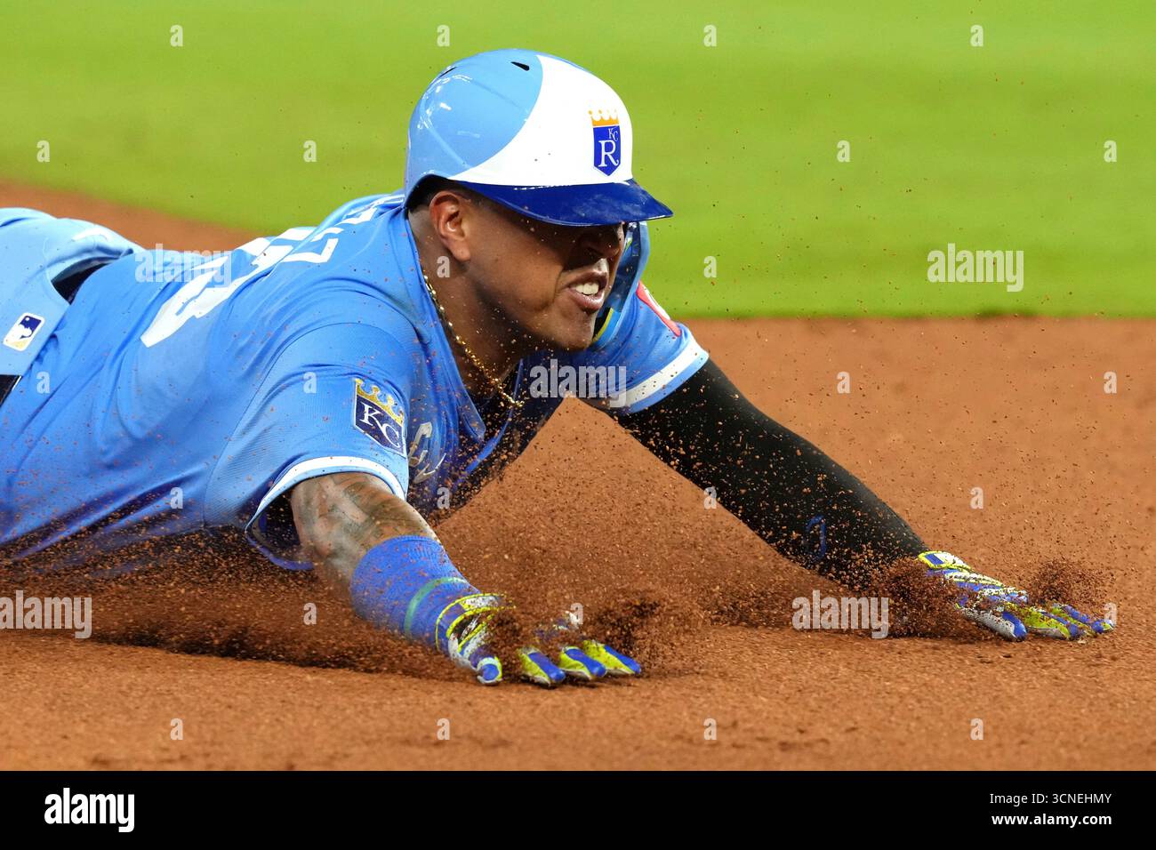 Kansas City Royals' Salvador Perez slides into third as he advances against the Toronto Blue ...