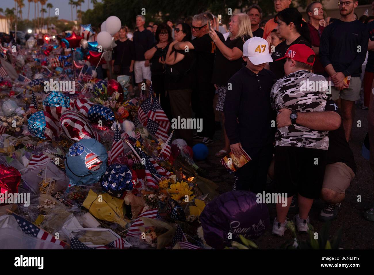 Arnie Scofield, right, hugs his son, Elijah, at a makeshift memorial ...