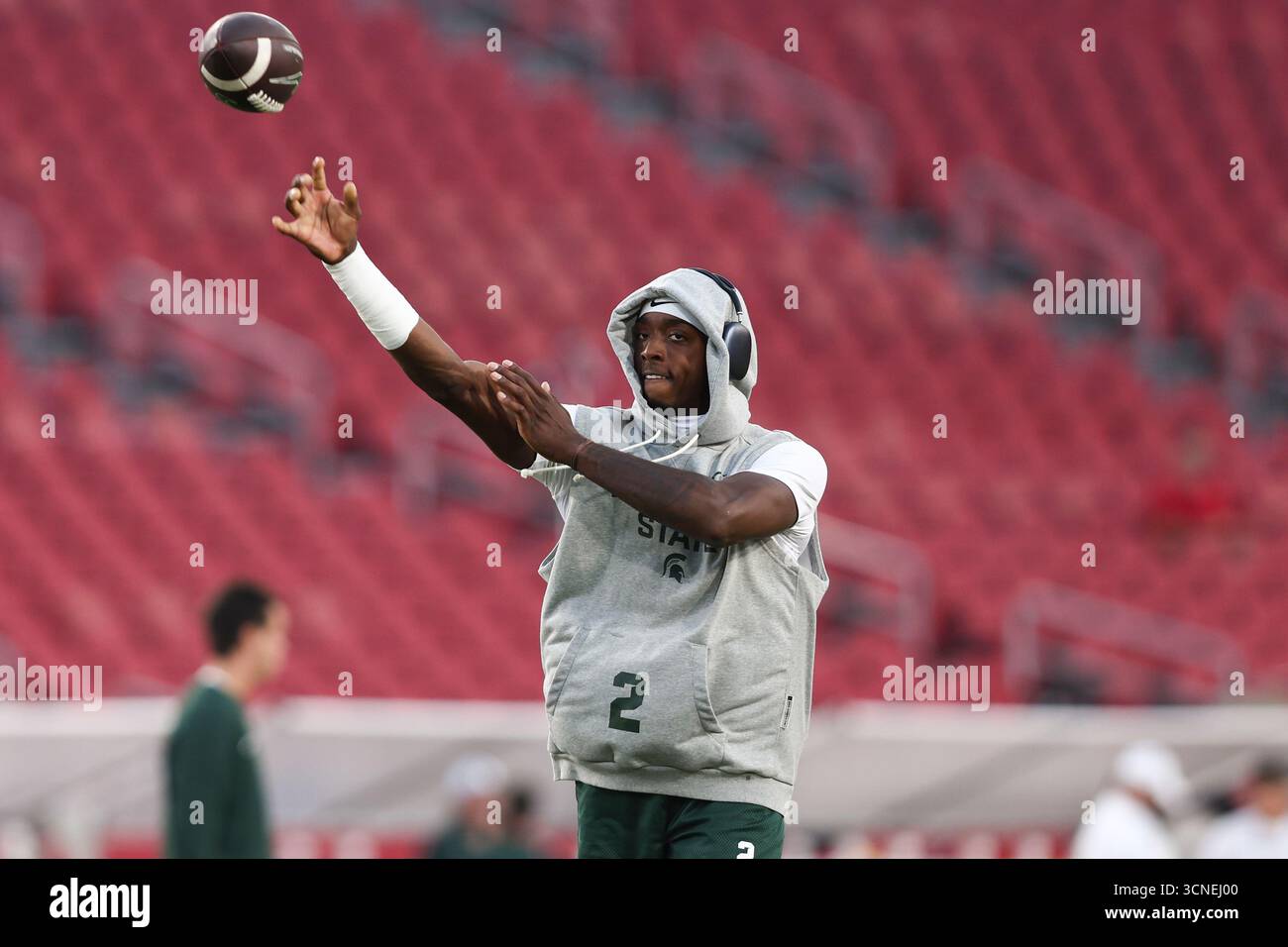 Michigan State quarterback Aidan Chiles warms up before an NCAA college ...