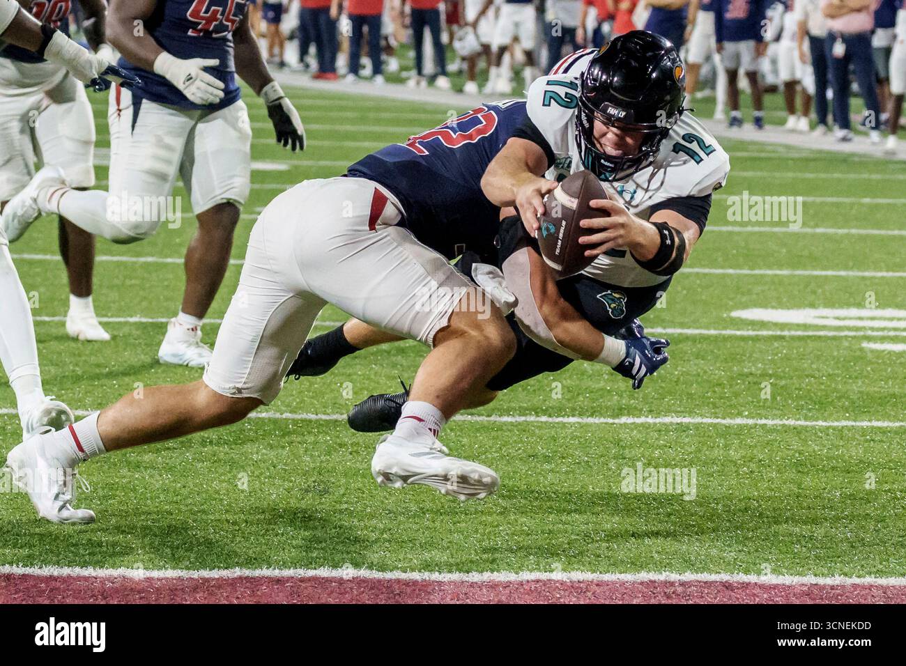 Coastal Carolina quarterback Tad Hudson (12) dives for the end zone ...