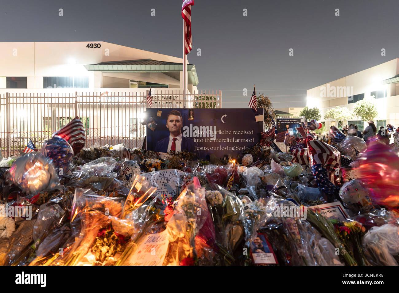 Flowers, candles, and balloons fill a makeshift memorial for Charlie ...