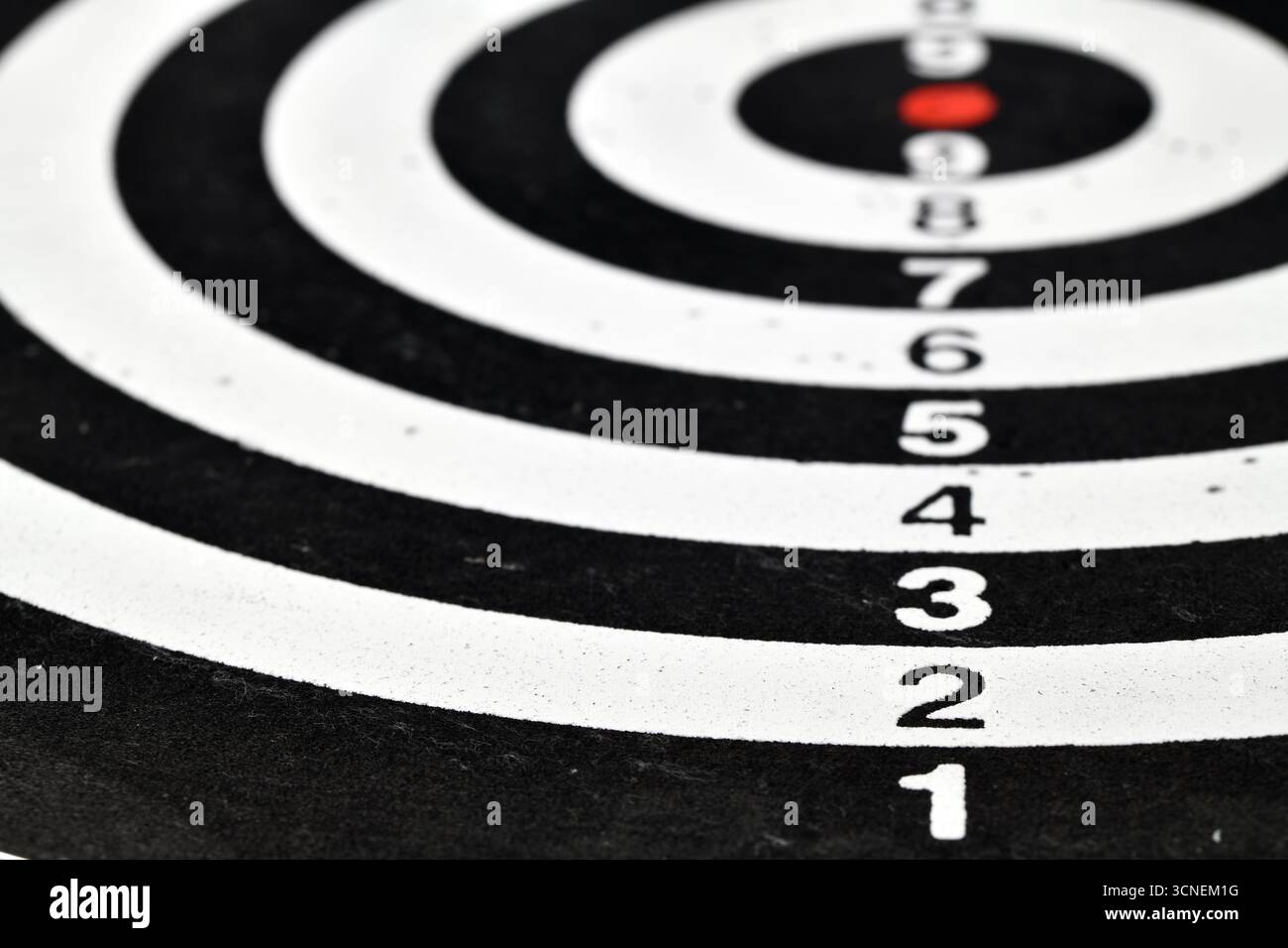 A black and white target with a red bullseye. The bullseye is ...