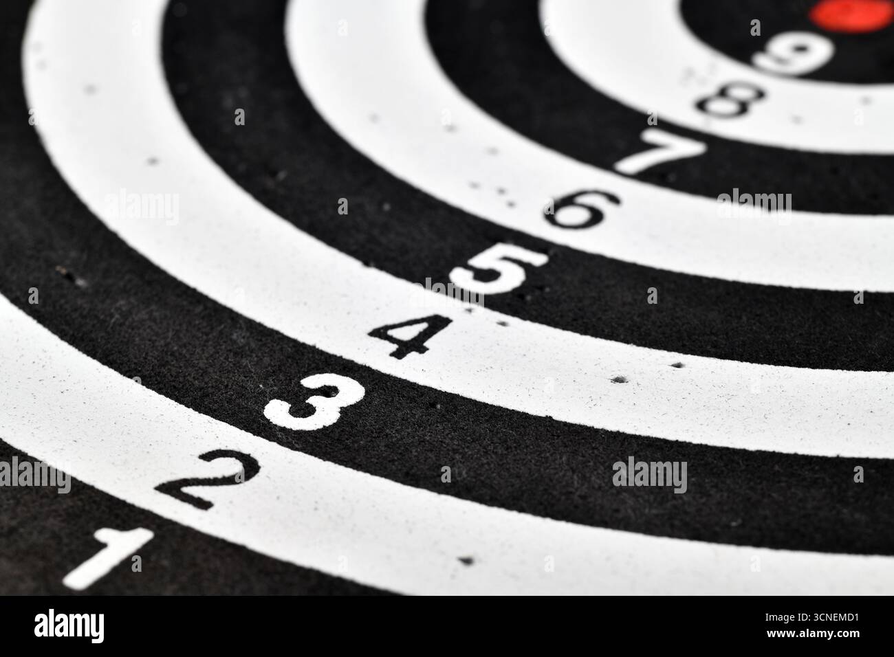 A black and white target with a red dot in the center. The numbers 1 ...