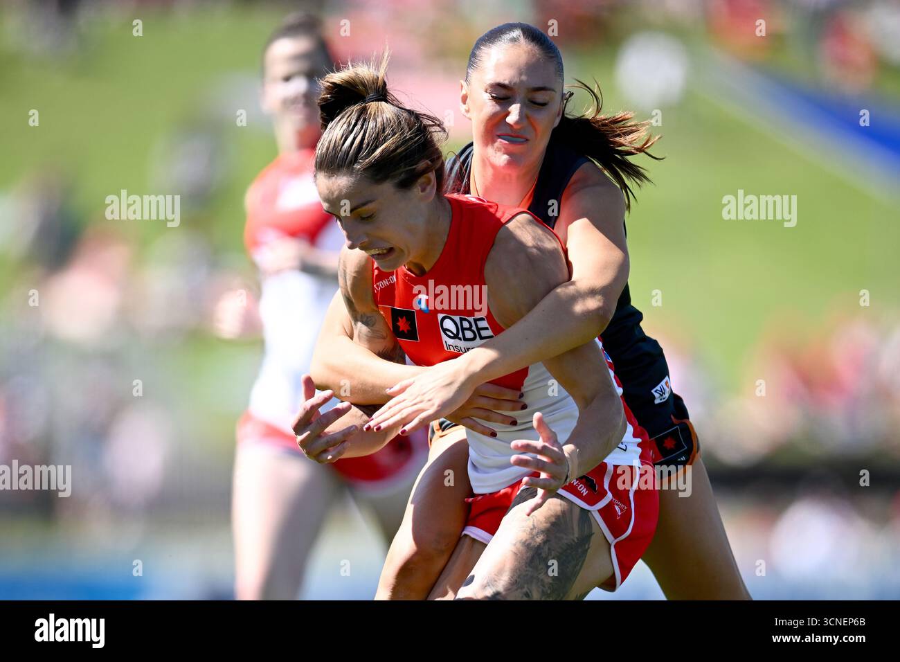 Tanya Kennedy of the Swans is tackled by Brodee Mowbray of the Giants ...