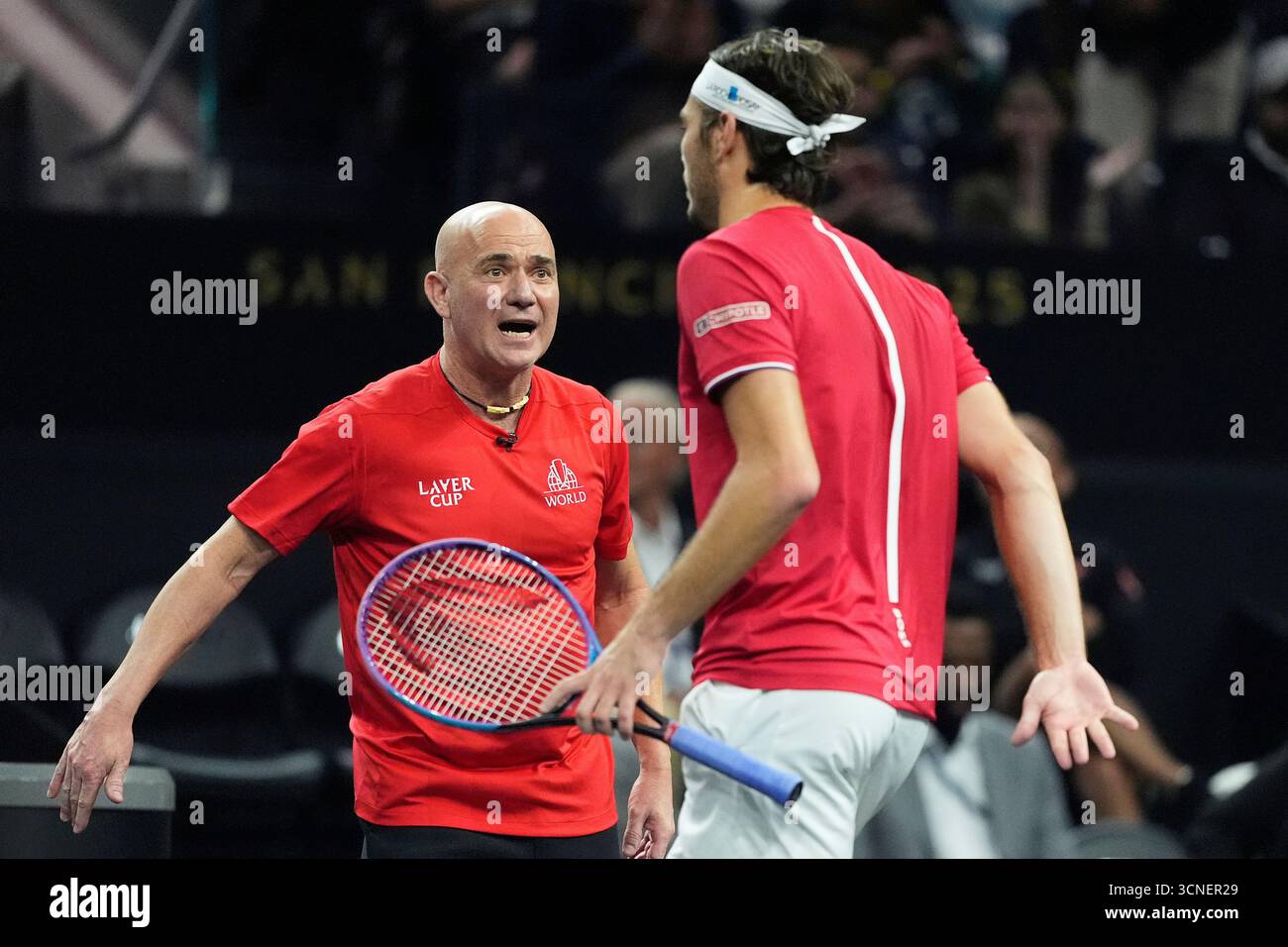 Team World captain Andre Agassi, left, reacts after Taylor Fritz, of ...