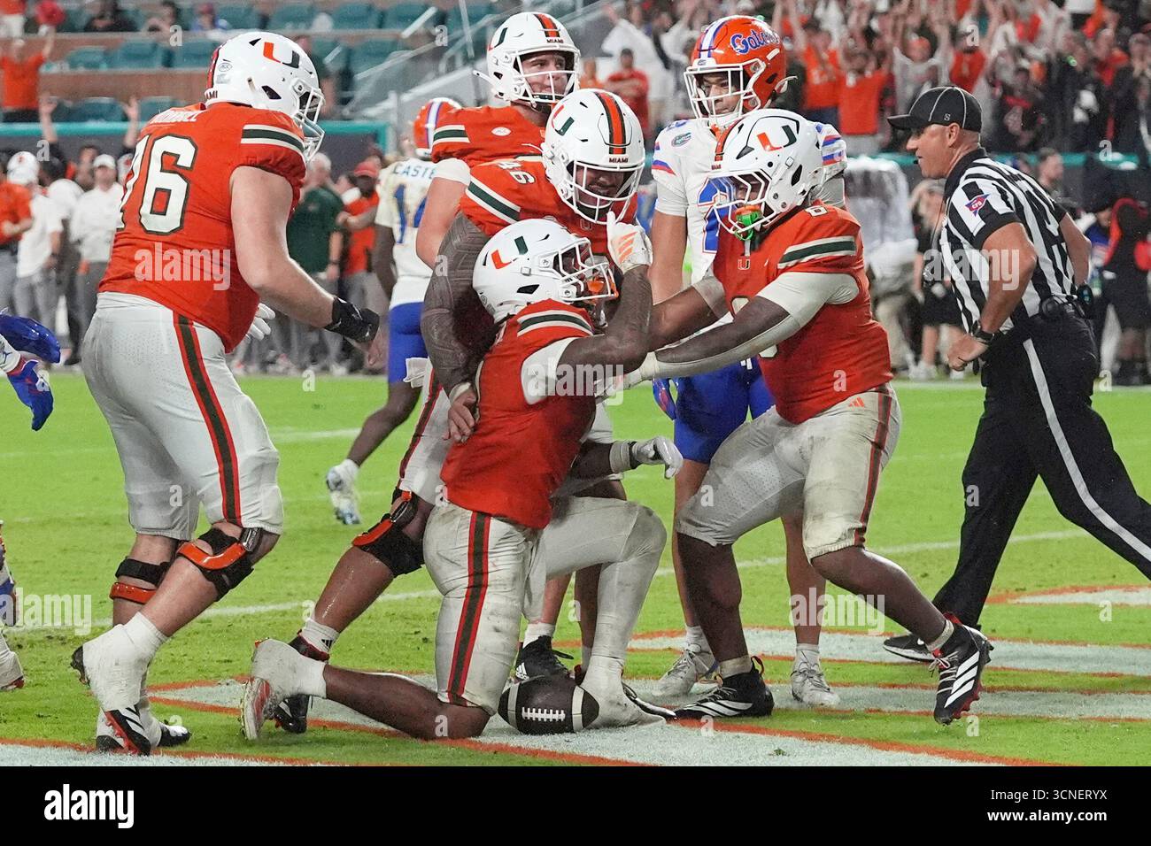 Miami running back CharMar Brown (6), center, celebrates with his ...