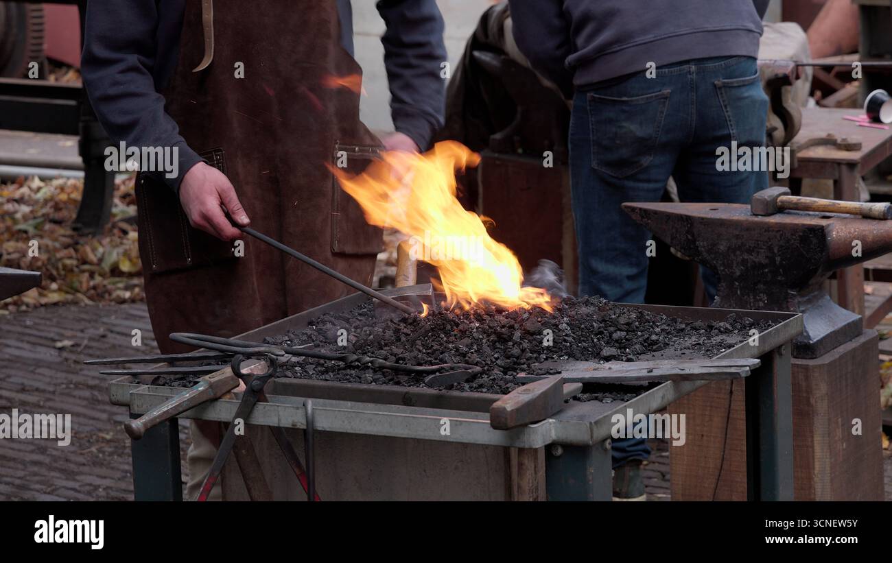 ROTTERDAM, NETHERLANDS - SEPTEMBER 13, 2025 - Blacksmith working metal ...