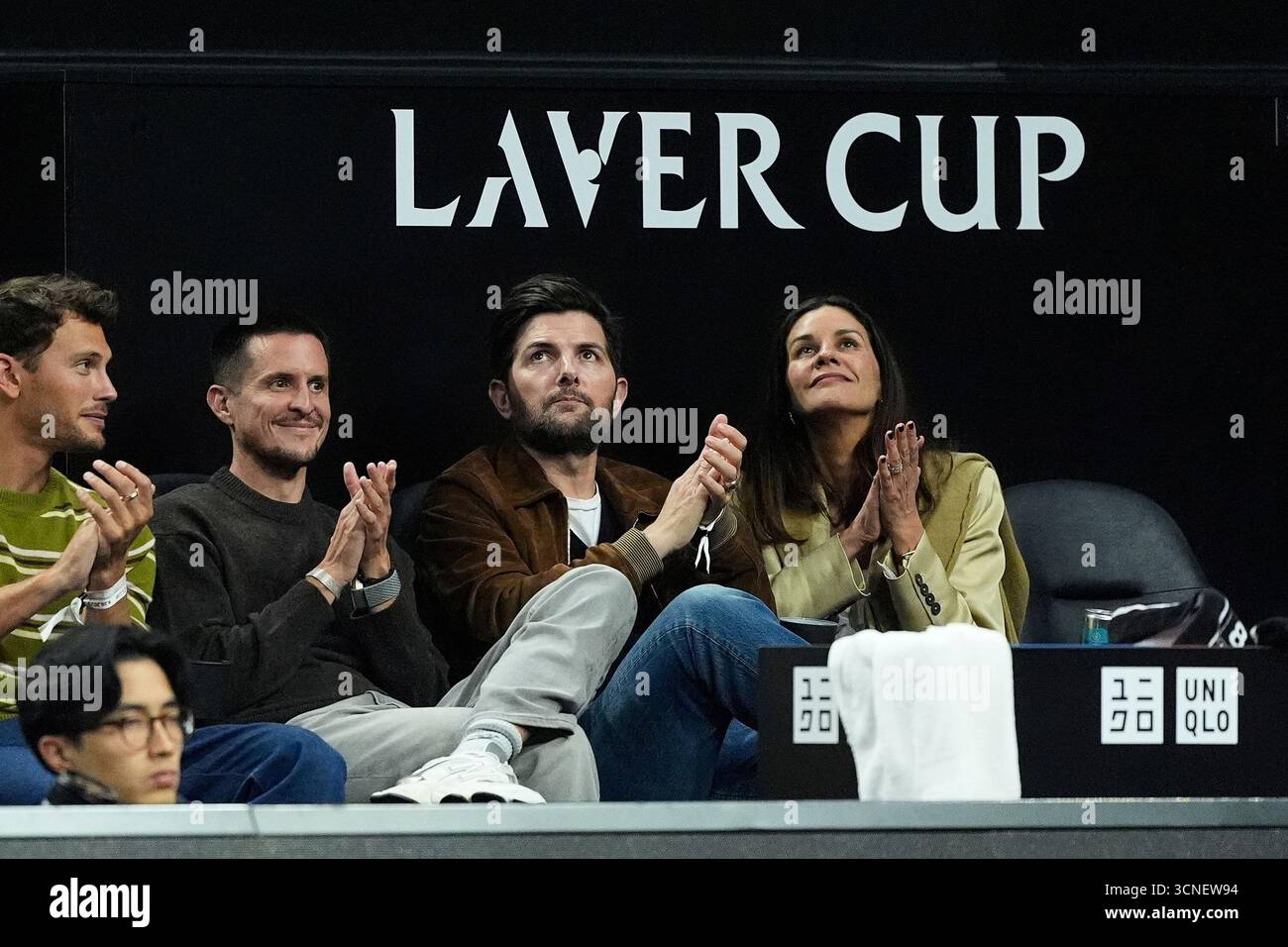 Actor Adam Scott, middle right, applauds during a match between Team ...
