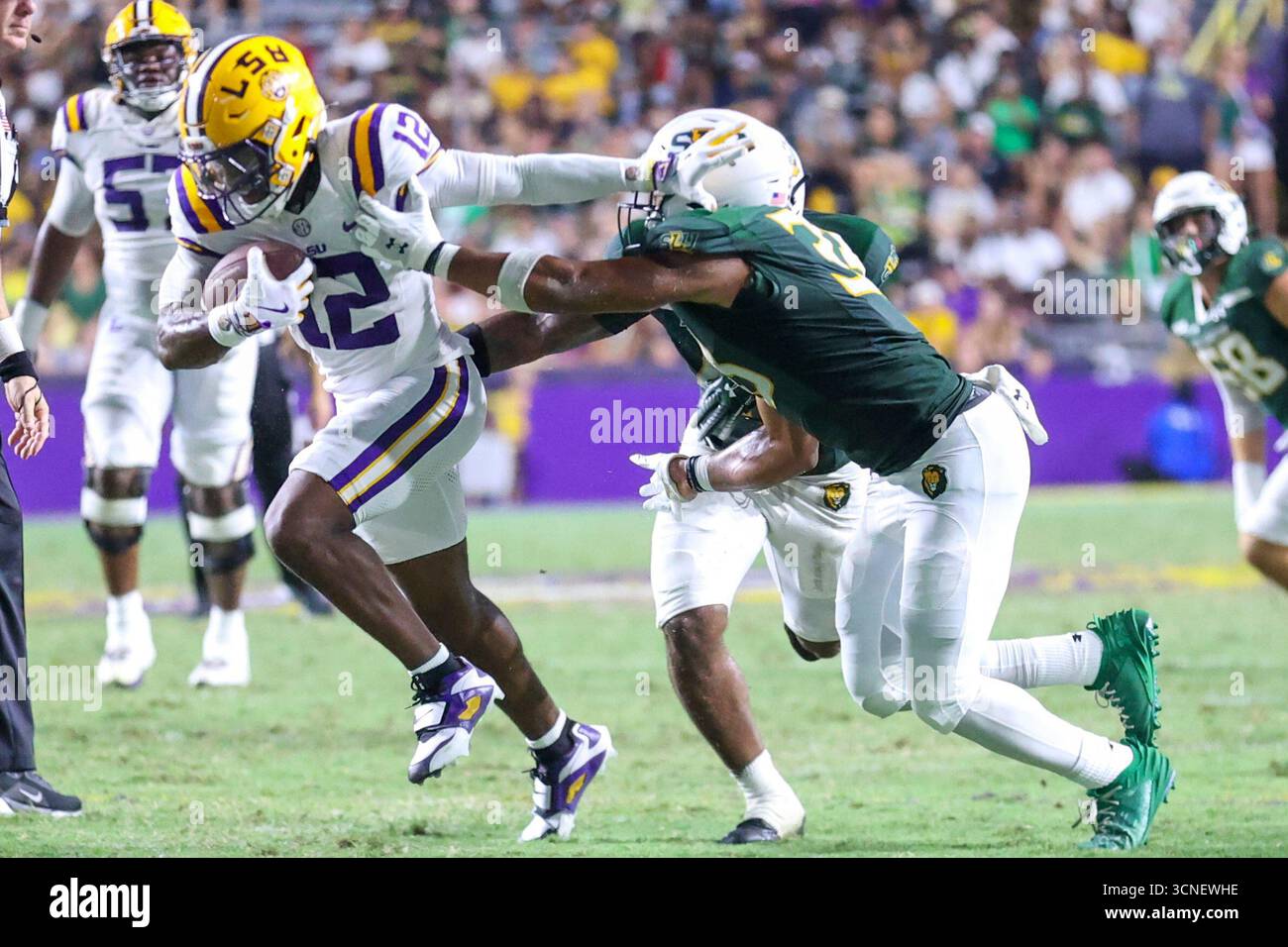 LSU wide receiver Kyle Parker (12) stiff-arms Southeastern Louisiana ...